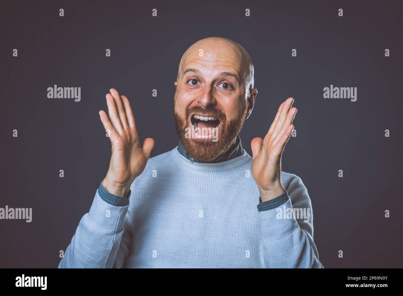 Photo of a caucasian nice guy with beard and blue background shouting ...
