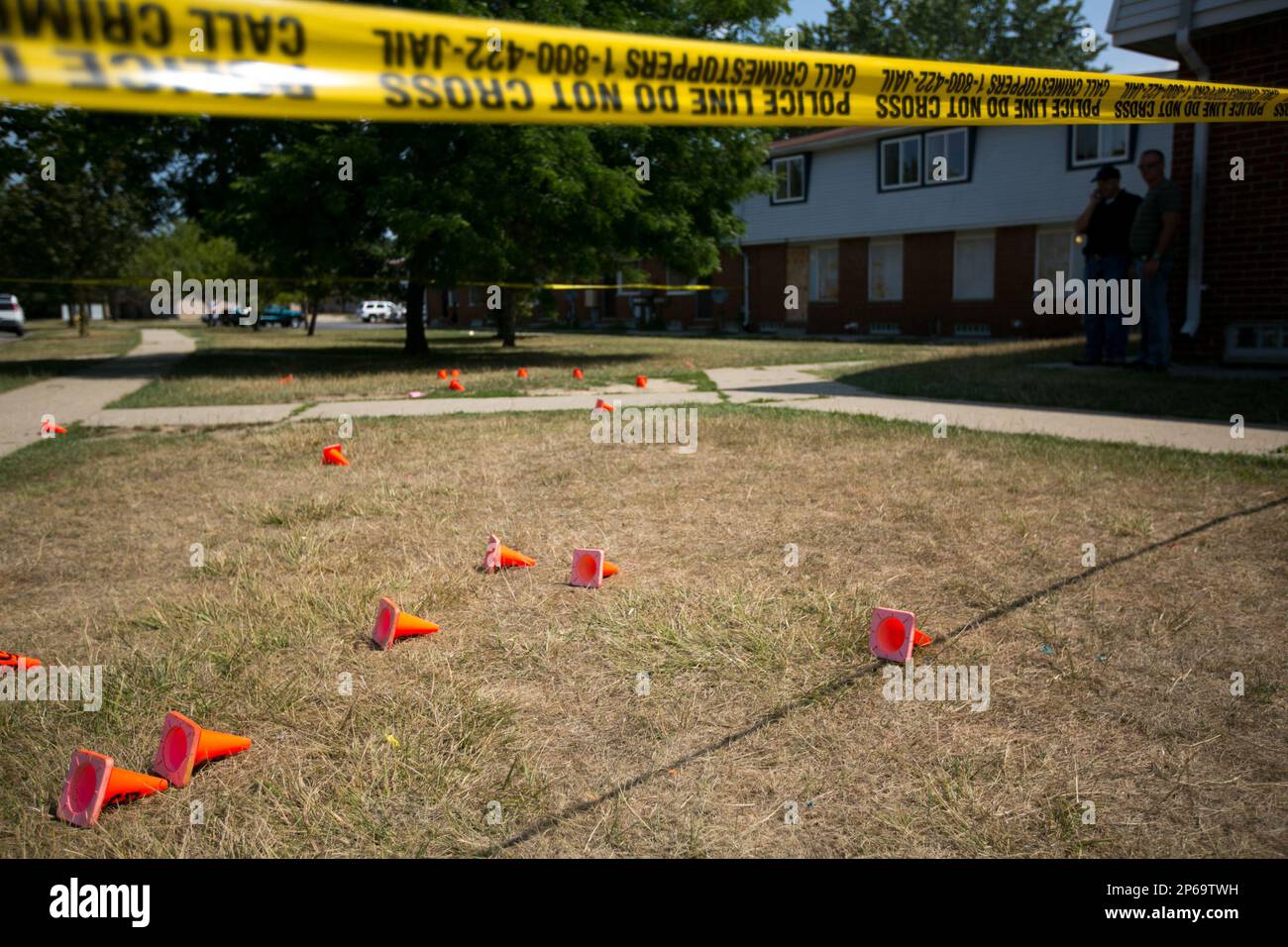 Evidence cones mark bullet shell casings and other items of interest ...