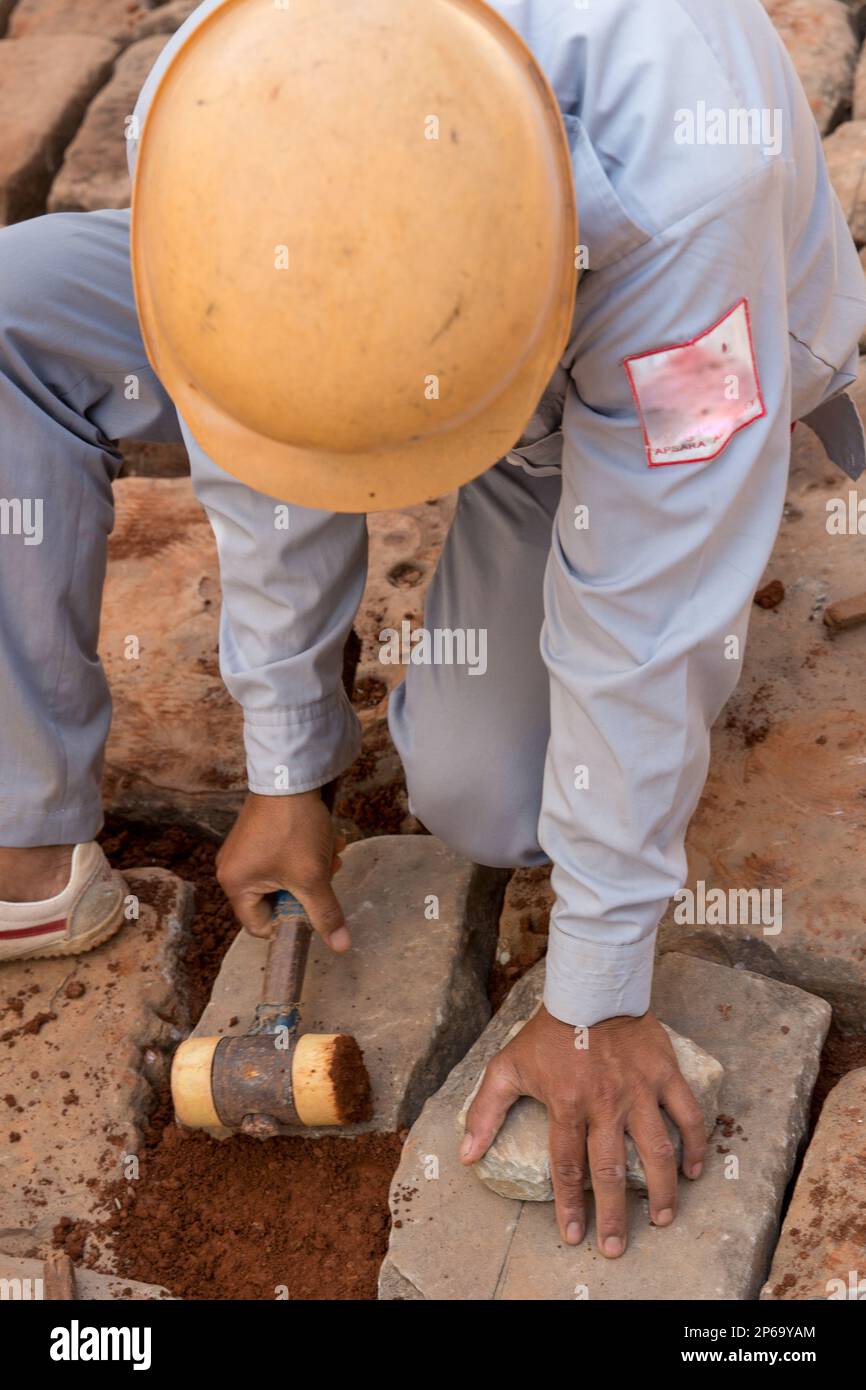 Construction worker restoring ruins in Cambodia Stock Photo - Alamy
