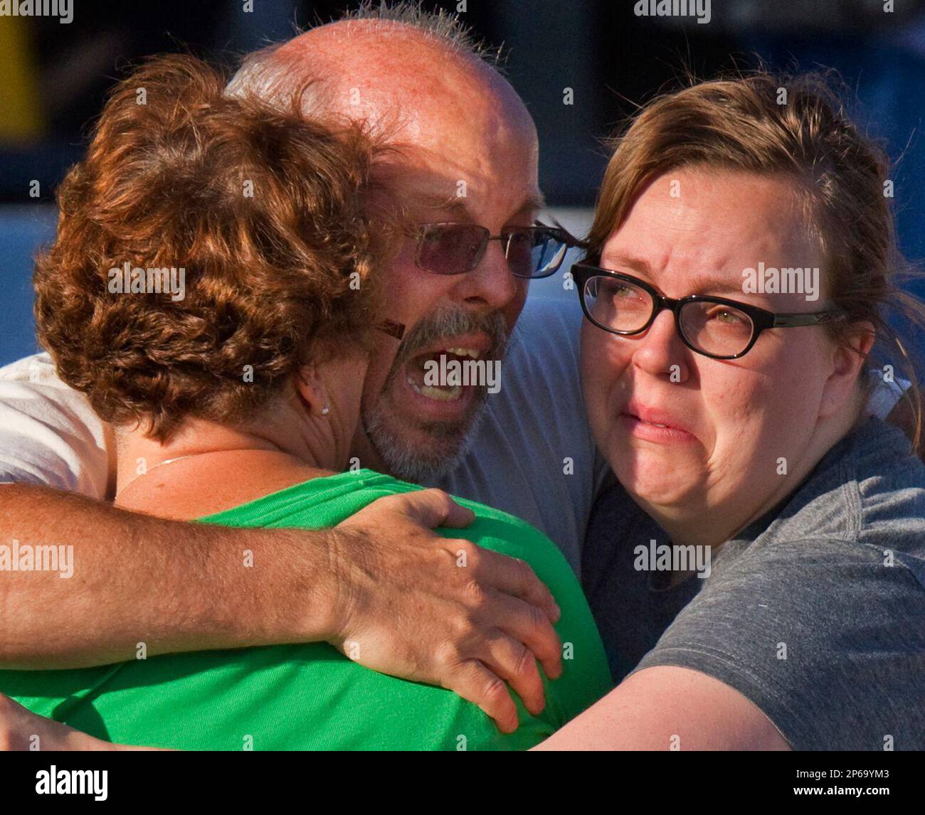 Tom Sullivan, center, embraces family members outside Gateway High ...
