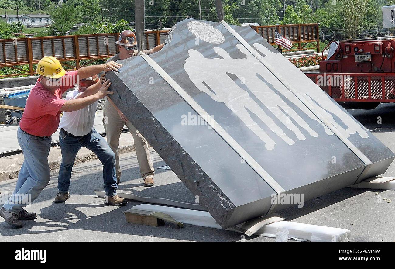 Workers with Beckley Crane & Construction Company lift one of the 5-ton ...