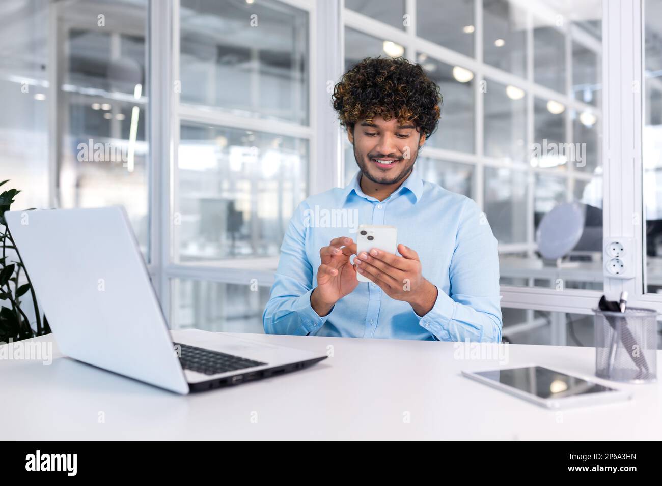 Young indian programmer inside modern office sitting at workplace, man ...