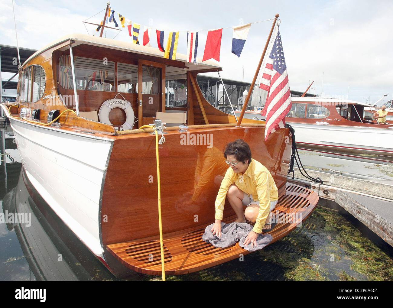 Karen Chikuami of Issaquah cleans the back of her 1946 Chris Craft ...