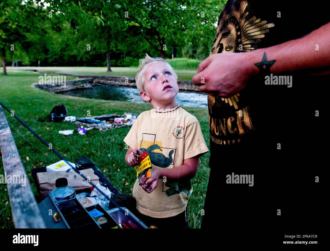 Devin Warner, 6, looks up at his stepdad Jon DeLattre while they put ...