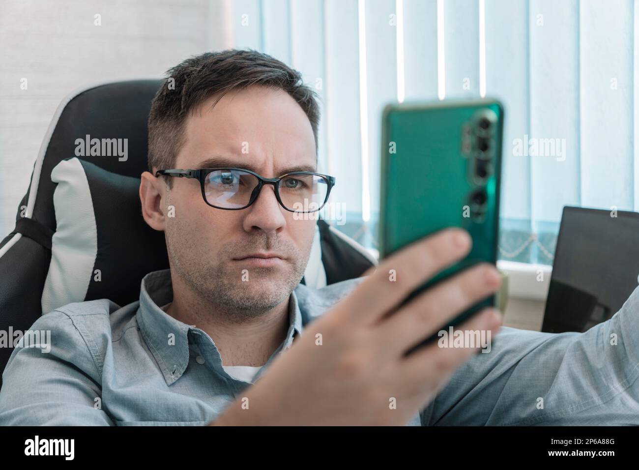 Concept of modern successful man. Young focused guy in glasses sitting ...