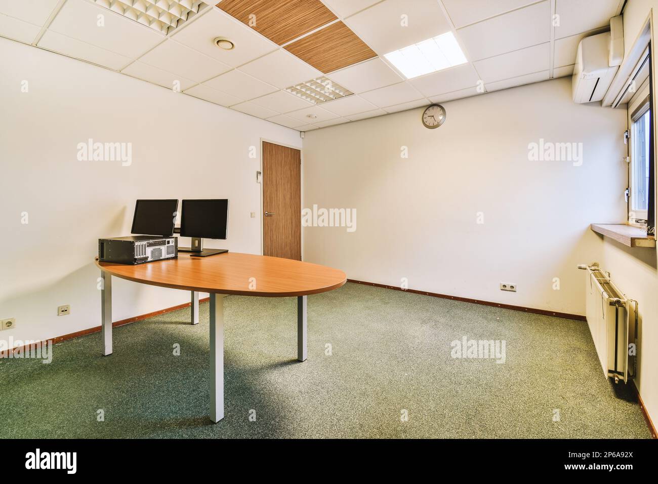 an office space with a desk and computer on the floor in front of a ...