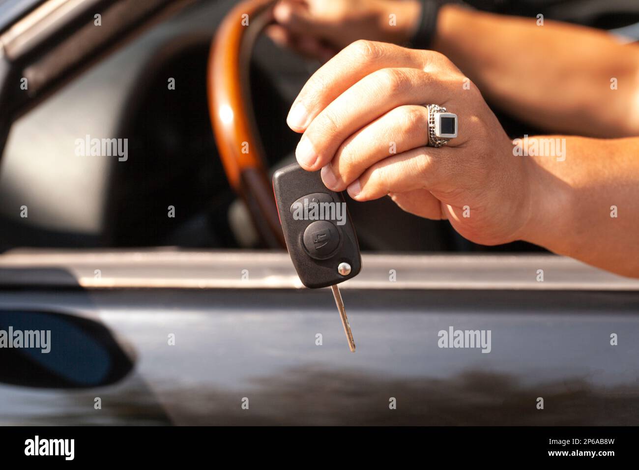 Car key in a man's hand with car Stock Photo - Alamy