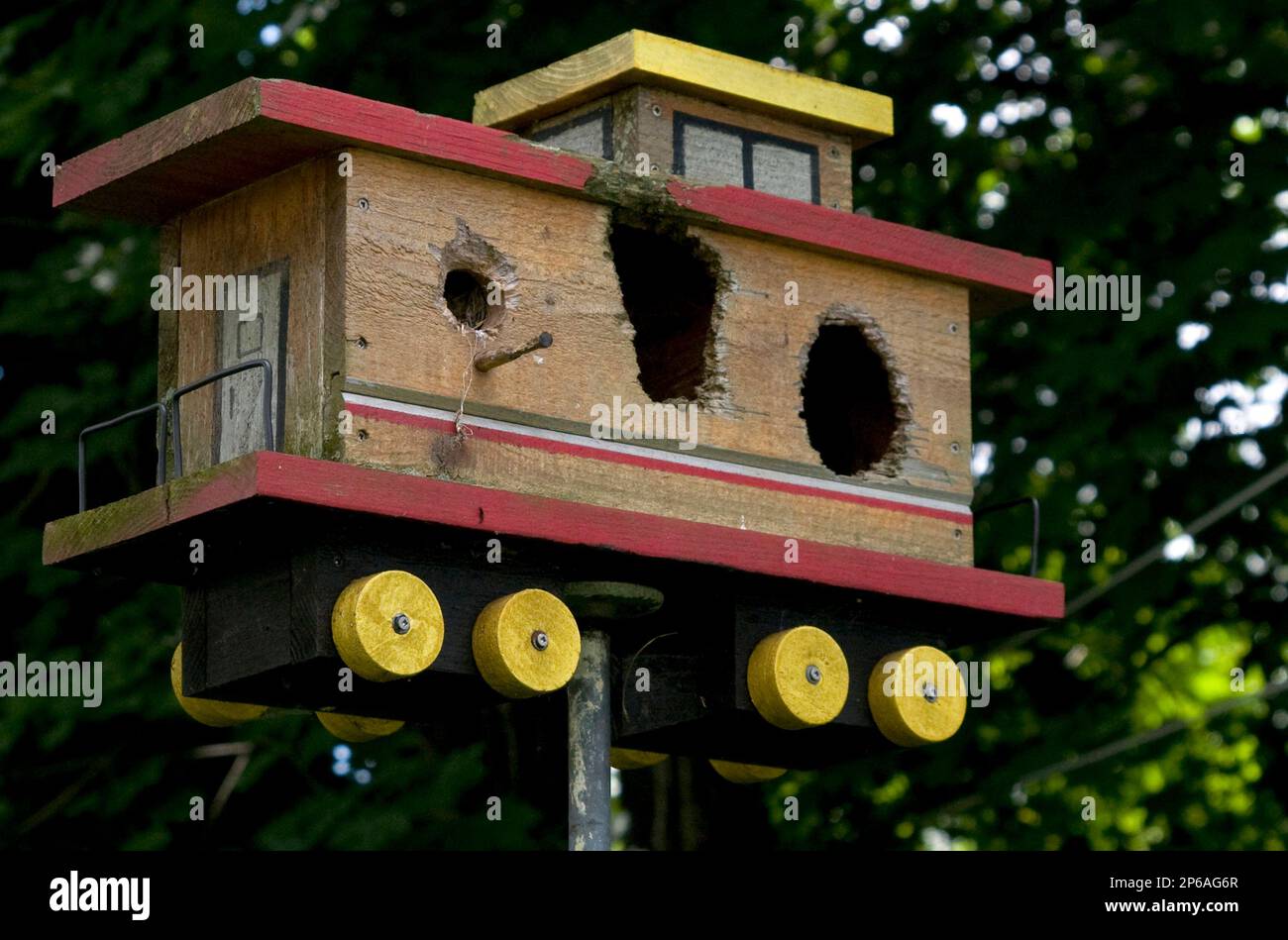 A birdhouse shaped like a train caboose sits in Vaughn Bates' backyard ...