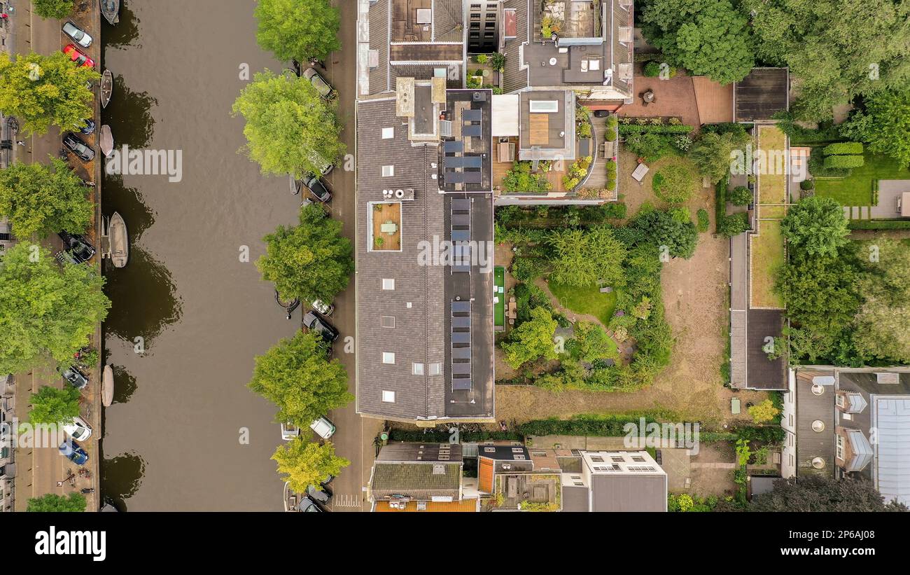an aerial view of houses on the water's edge, with trees and buildings ...