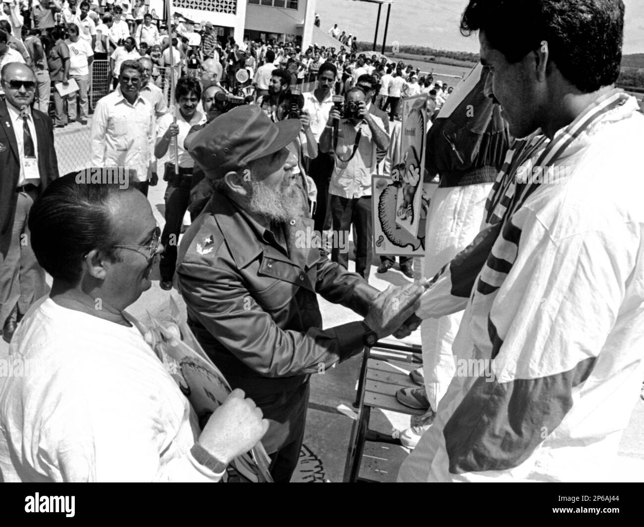 Cuban leader Fidel Castro, center, congratulates an unidentified award ...