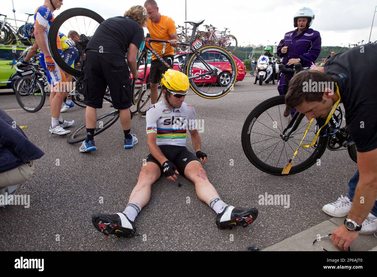 Mark Cavendish of Britain sits on the road after crashing in the last ...