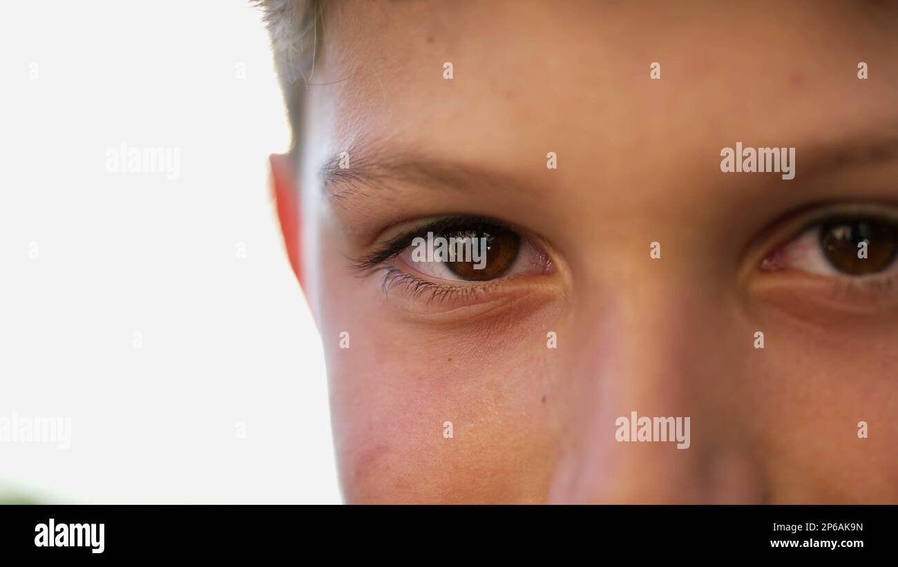 One teen young oby macro eyes close up looking at camera. Kid child ...