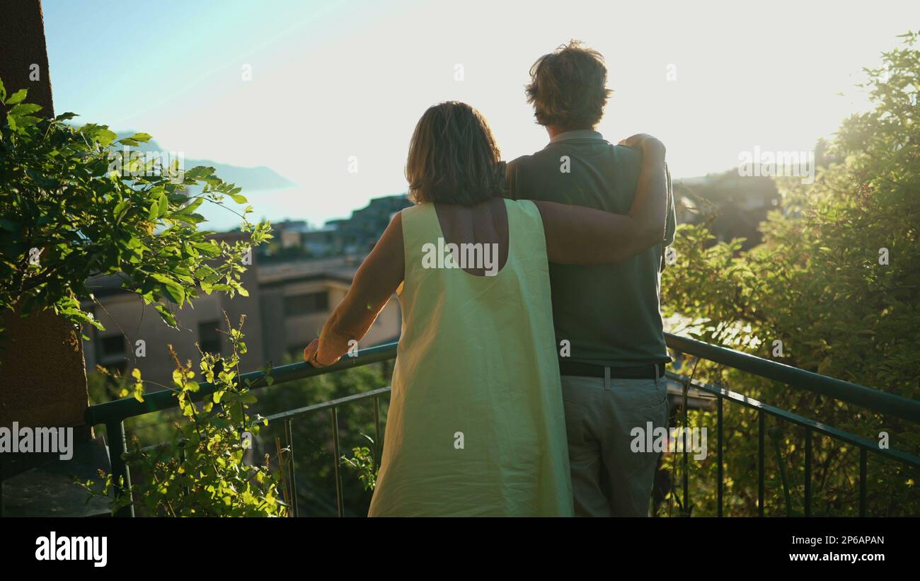 Back of a senior couple standing outdoors looking at scenic view. A ...