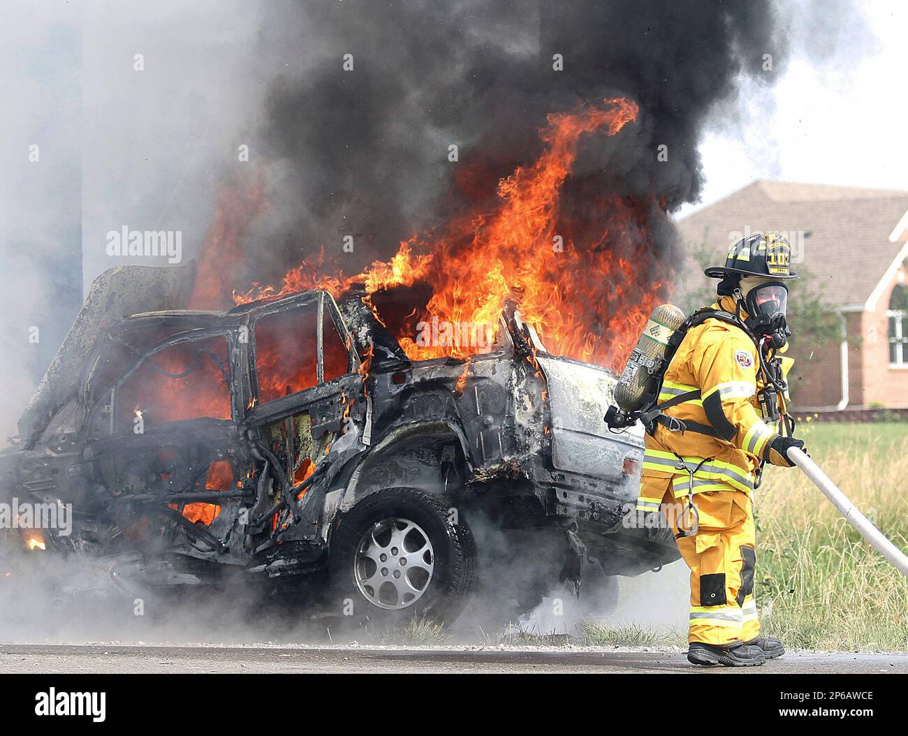 An Anna firefighter sprays water towards a burning vehicle that caught ...