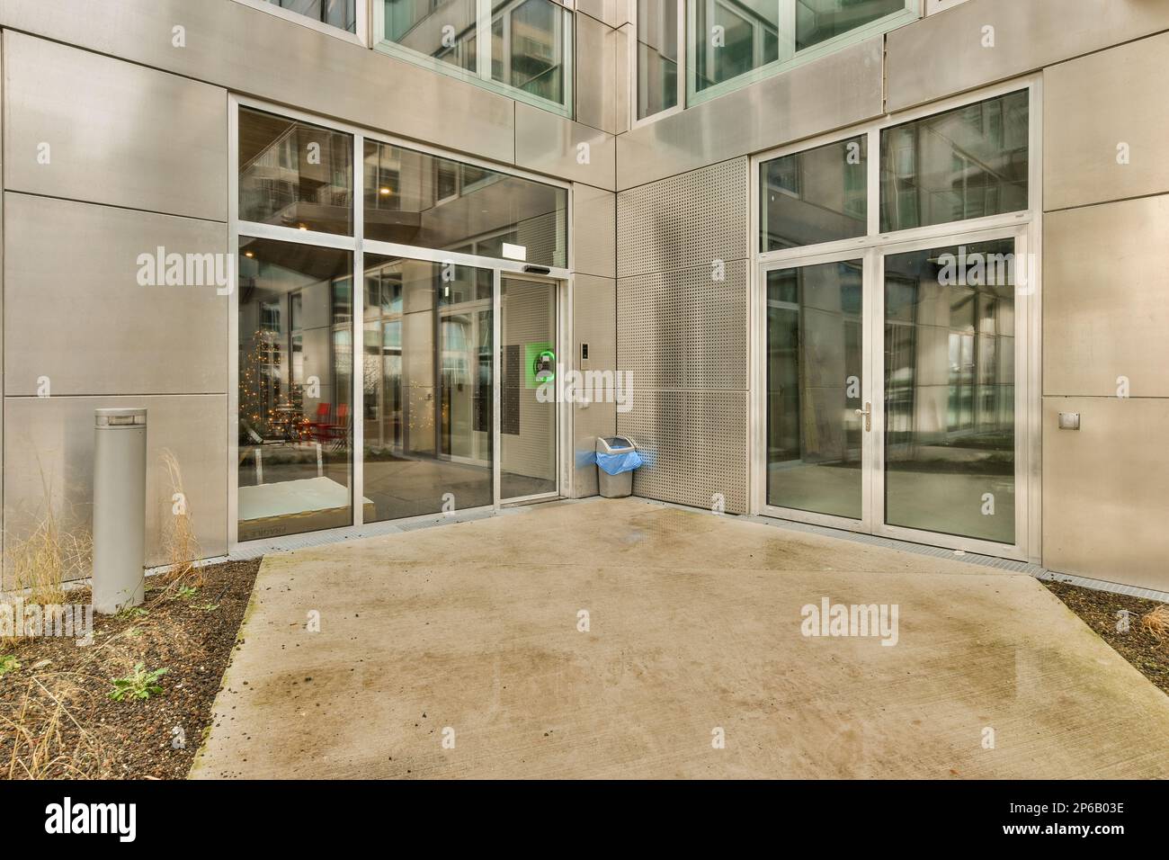 the outside of a building with glass doors and an open area for people ...