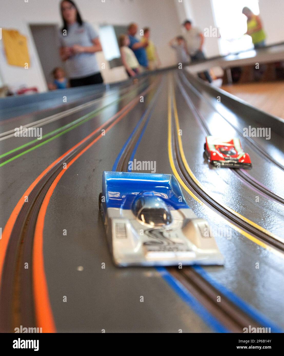 Slot cars zip around the 7-lane slot car track at A Main Speedway in ...