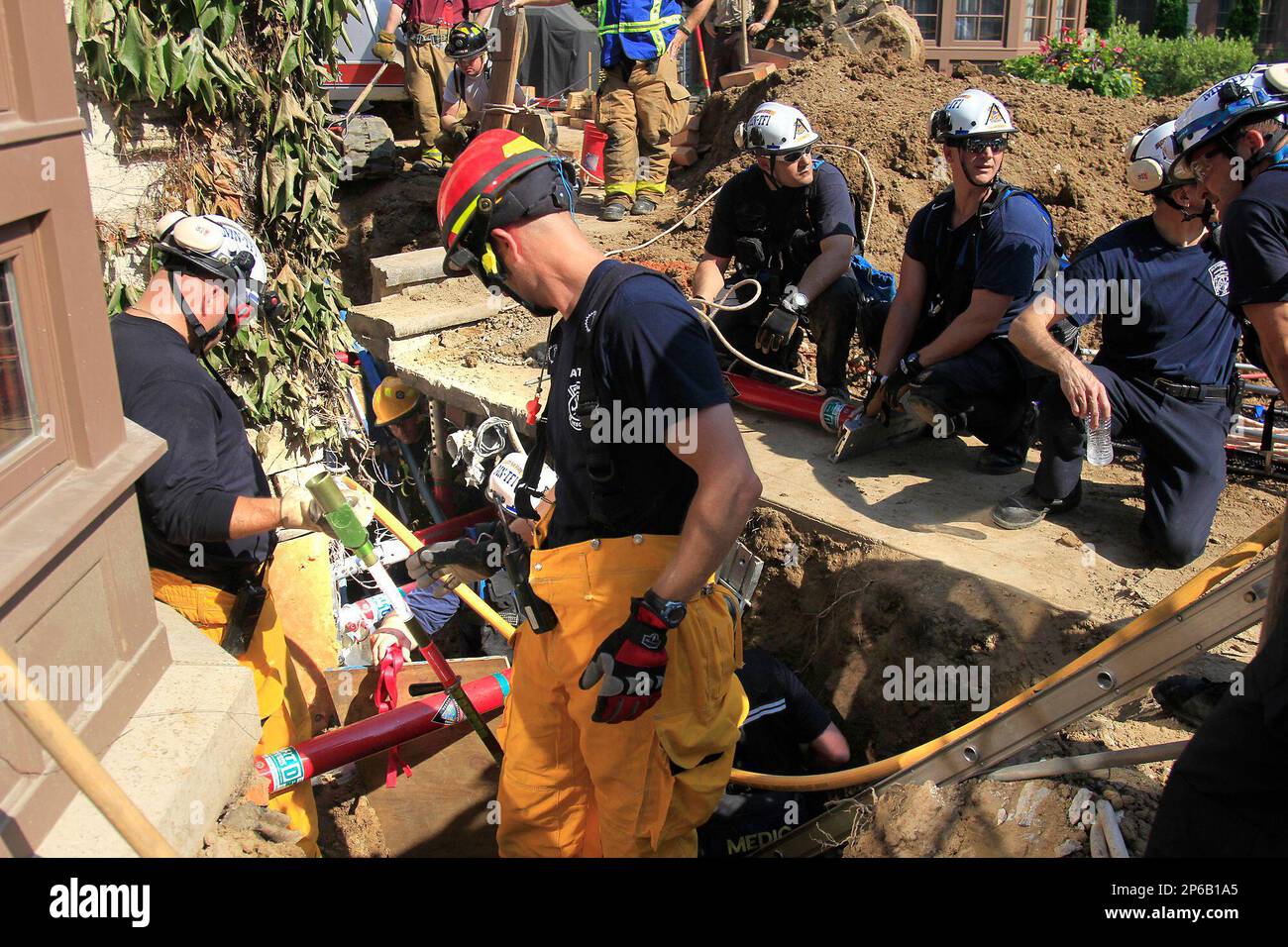 Twin Cities rescue crew work on extracting a construction worker from a ...