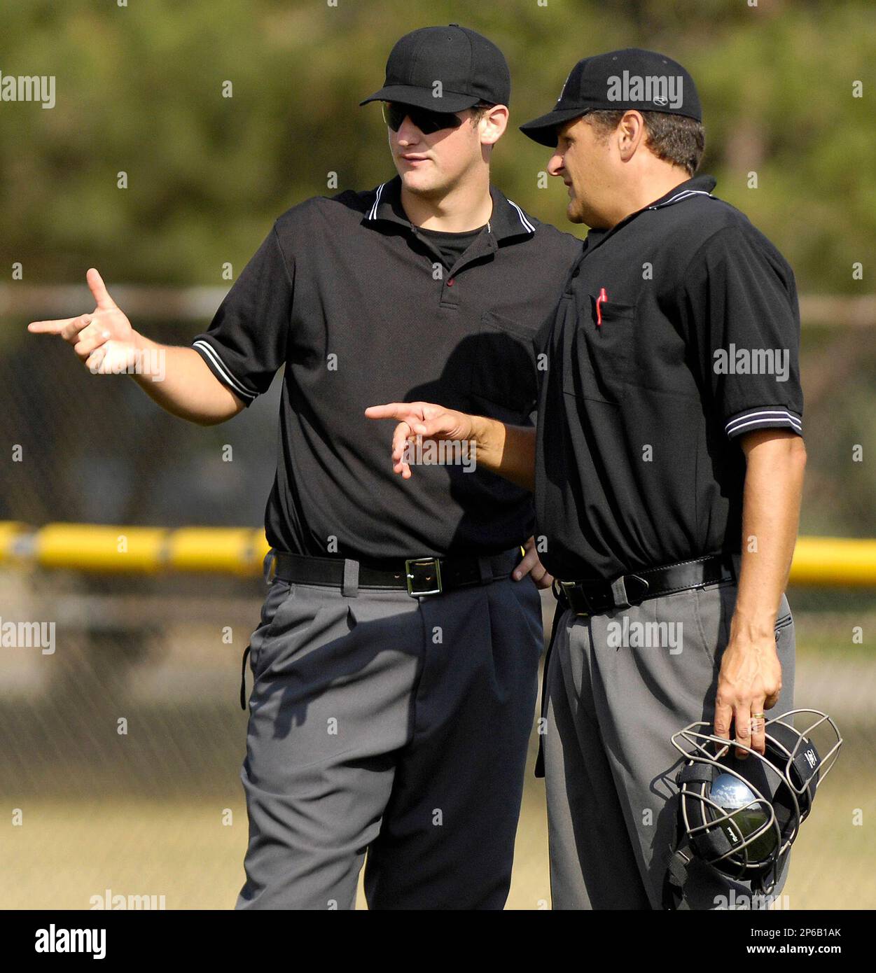 Umpires Tim Farwig, right, and his son Augie Farwig talk between ...