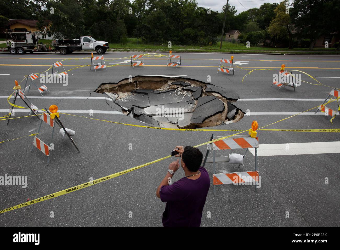 Hector Aviles, 30, of Spring Hill, Fla. shoots video of the sinkhole in ...