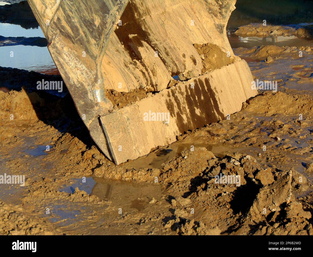 the bucket of an excavator in the mud Stock Photo - Alamy