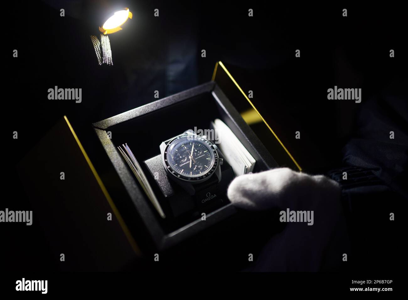 Customers look at their new MoonSwatch during the launch at the Swatch ...