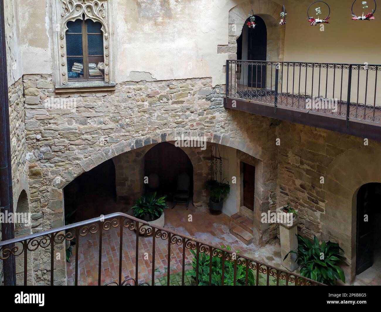 A charming balcony in a historic building, adorned with plants and ...