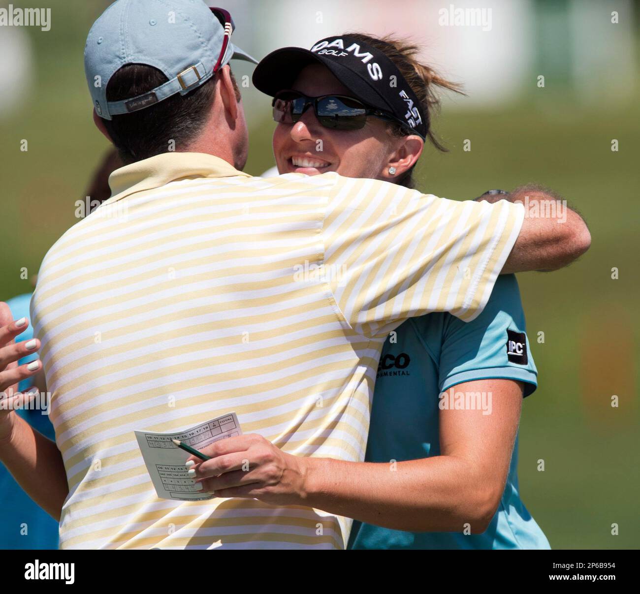 Brittany Lang, of the United States, gets a hug from Meena Lee's caddie ...