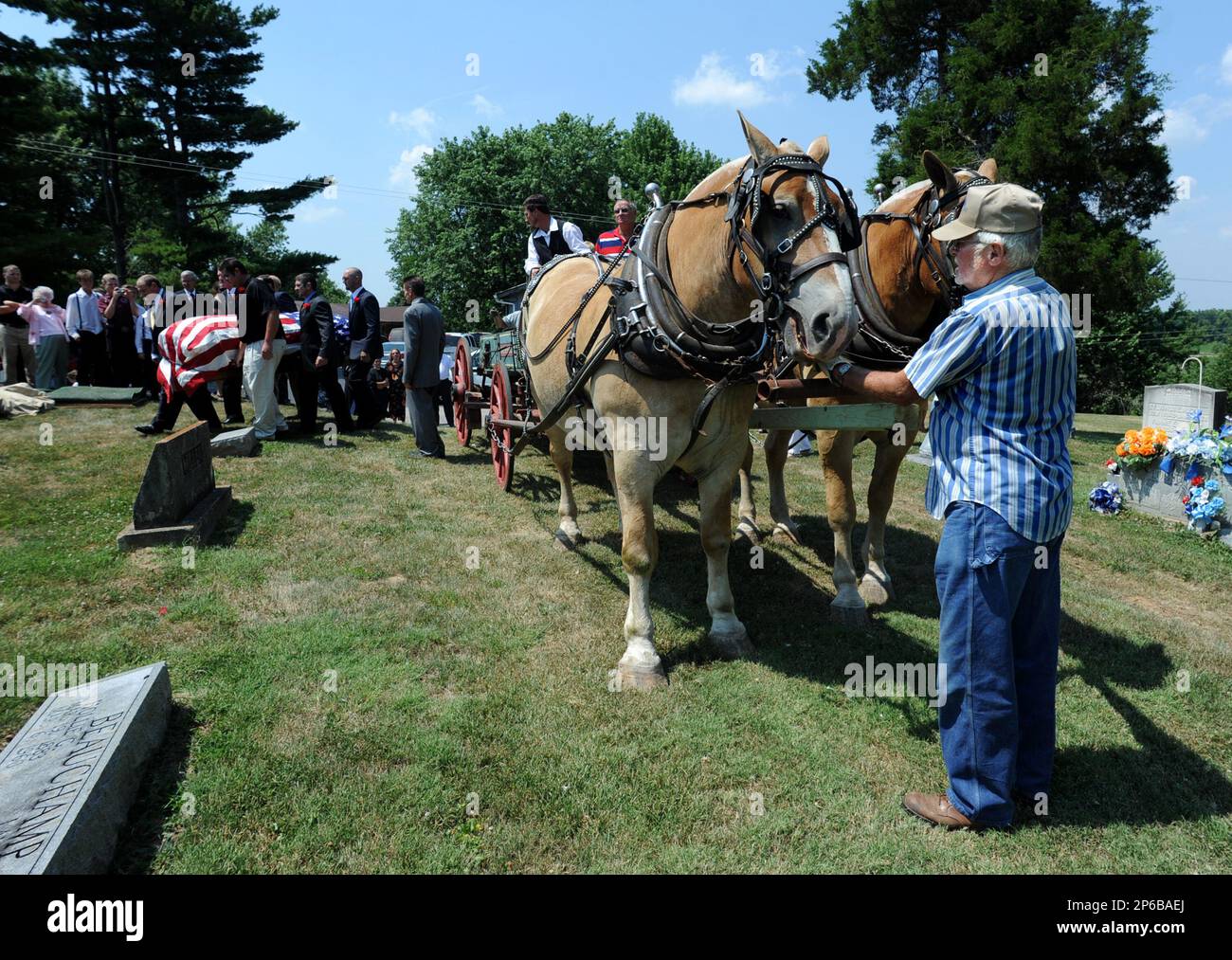 Charlie Fackler. right, of Brandenburg,, holds the harness of a Belgian ...