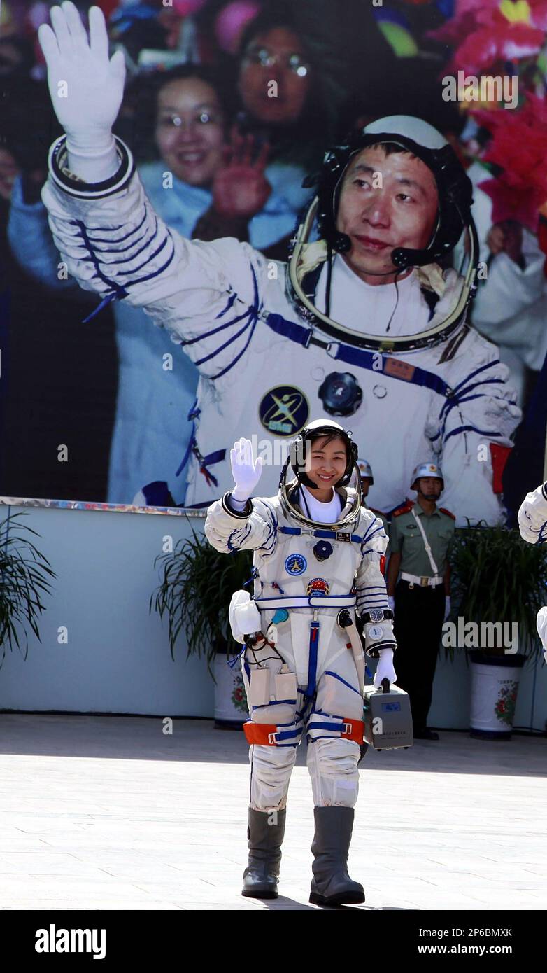 Chinese astronaut Liu Yang walks in front of a portrait of astronaut ...