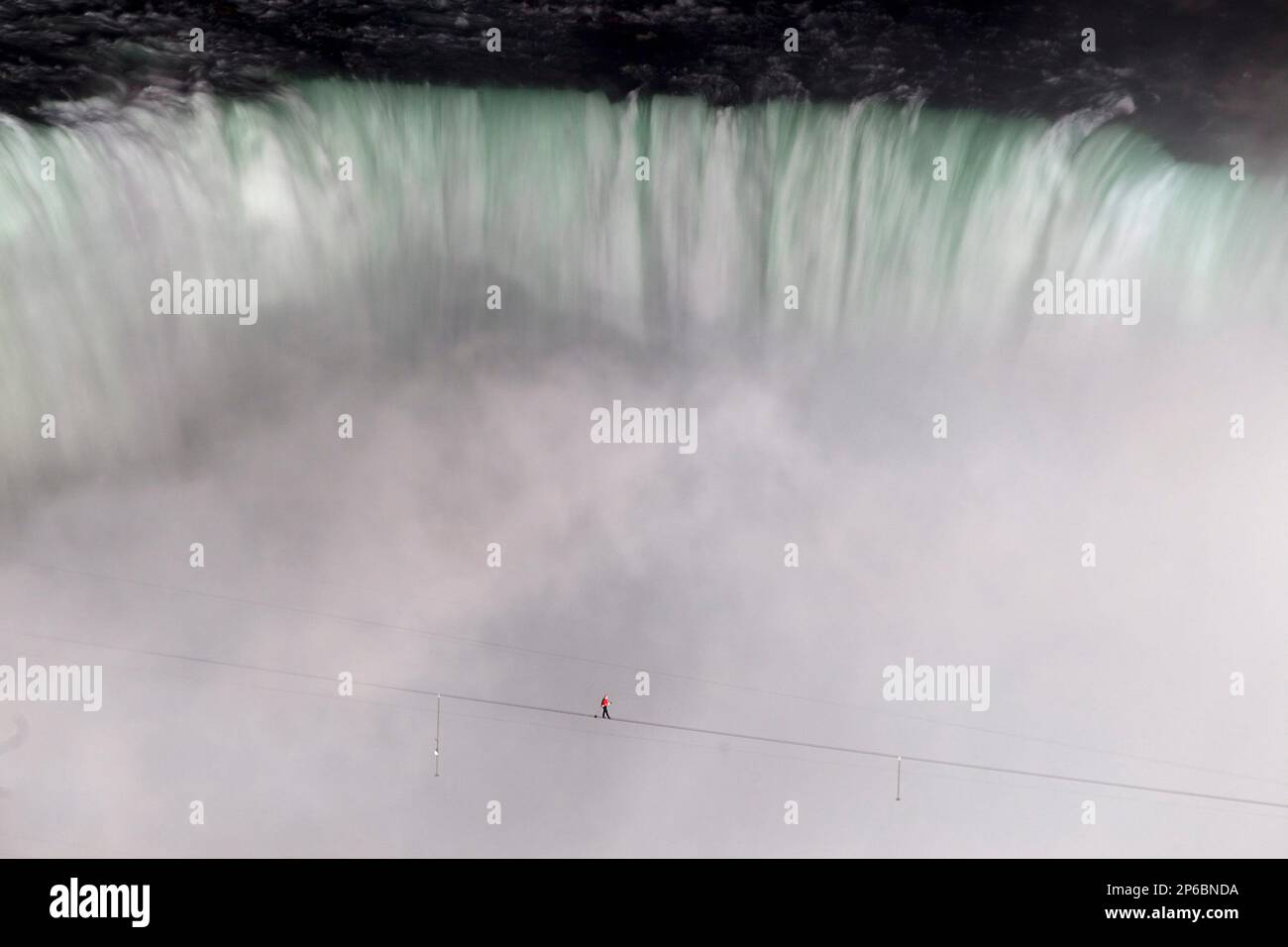 Nik Wallenda walks over Niagara Falls on a tightrope as seen from ...