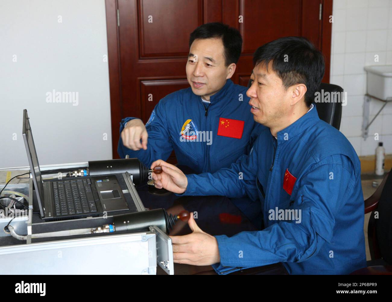 Chinese astronauts Liu Wang (R) and Jing Haipeng (L) attend a training ...