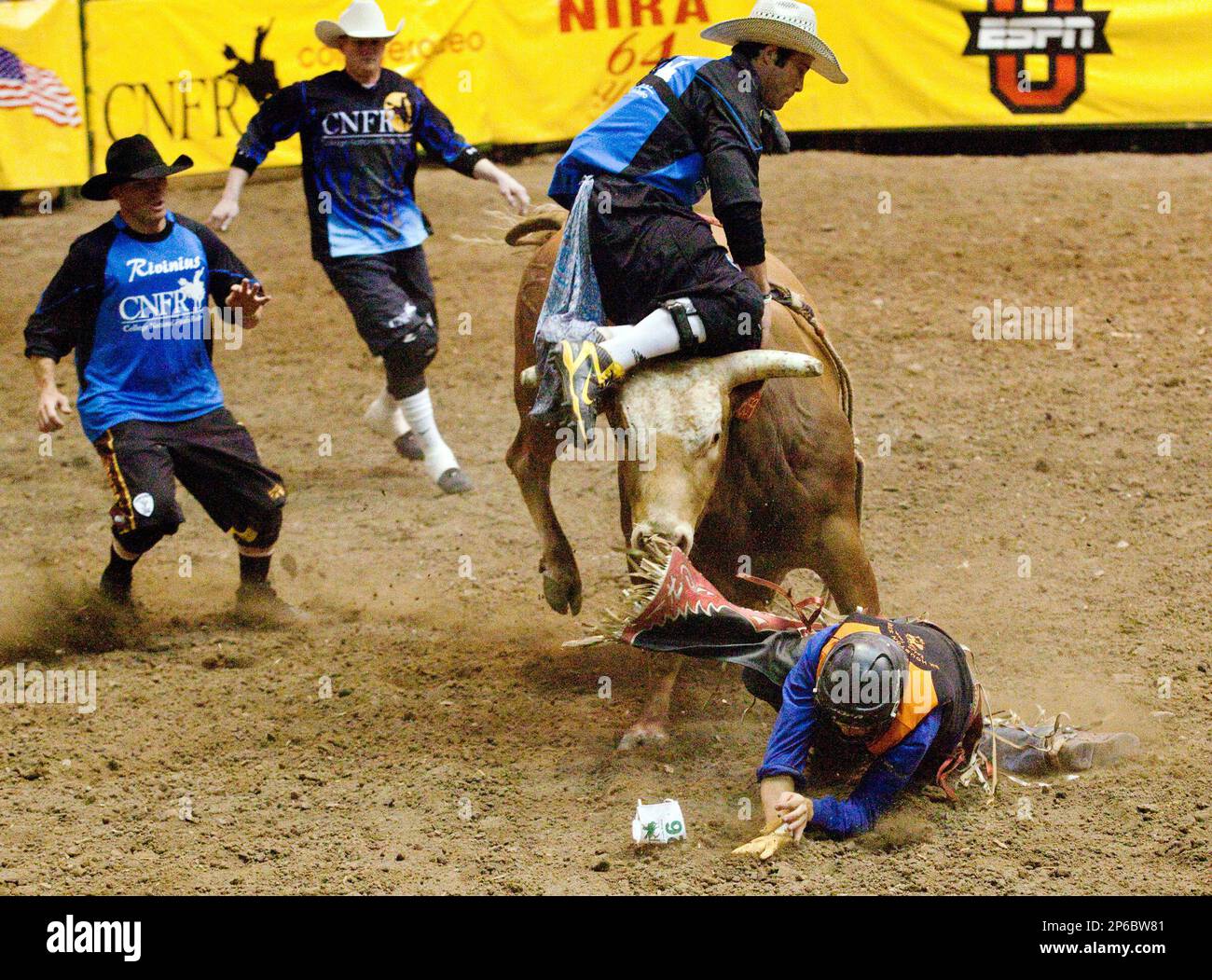 Bull fighter Dusty Tuckness leaps onto the head of Live Hostage after ...