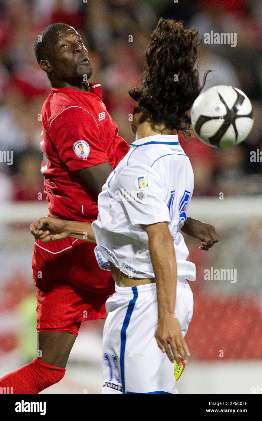 Canada's Toisaint Ricketts, left, flicks a header past Honduras' Roger ...