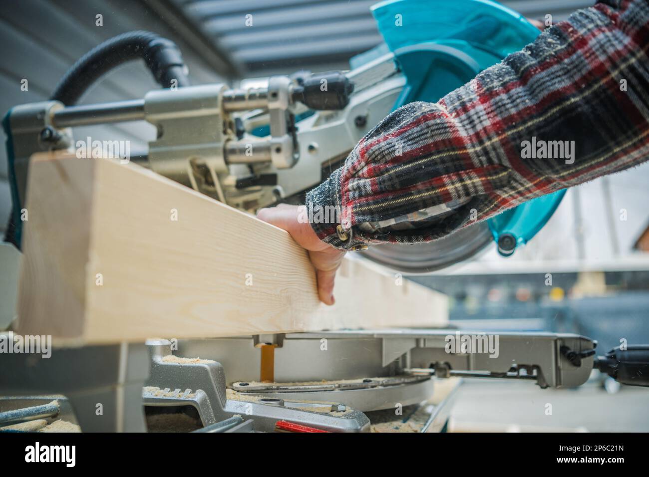 Construction Woodworker Cut a Beam to Size Using Powerful Wood Saw ...