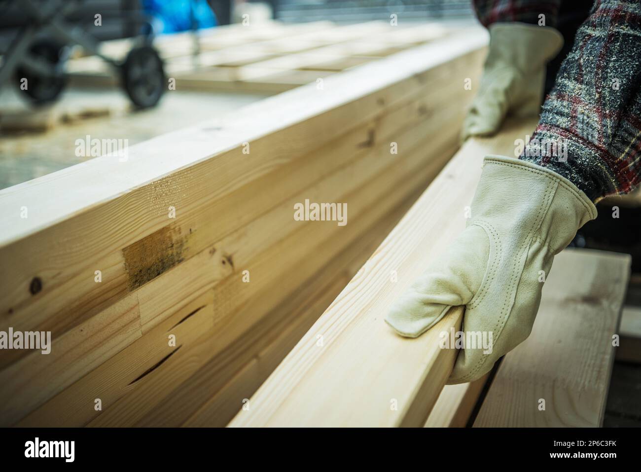 Woodworker Selecting Wood Beam For His Construction Project. Industrial ...