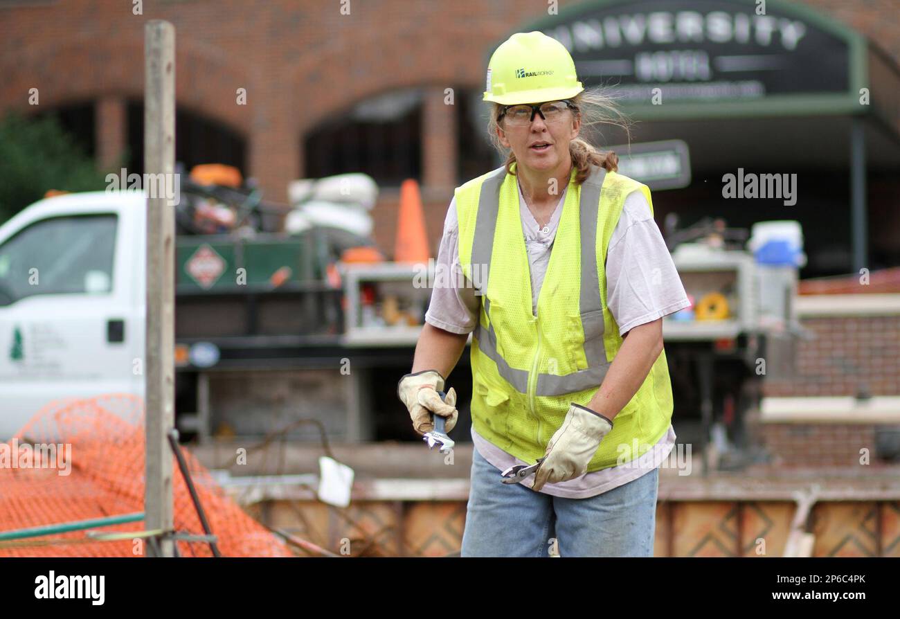 In this May 25, 2012 photo, RailWorks laborer Lisa Becker measures and ...