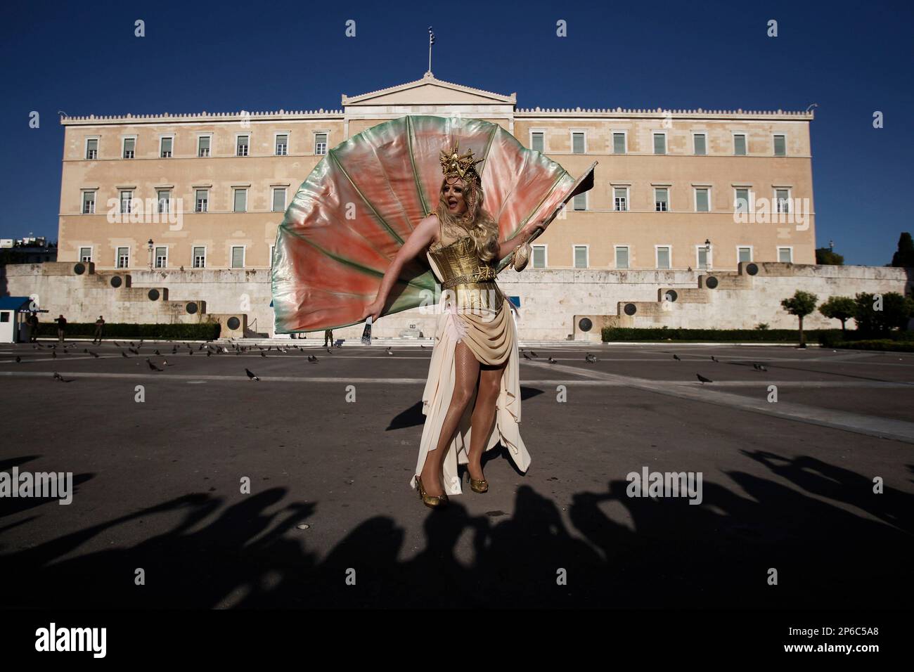 A Drag Queen performer poses for photos during a Gay Pride event march ...