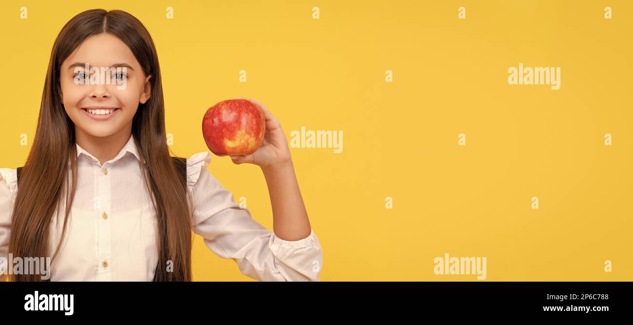 happy school kid in uniform hold apple. Child girl portrait with apple ...