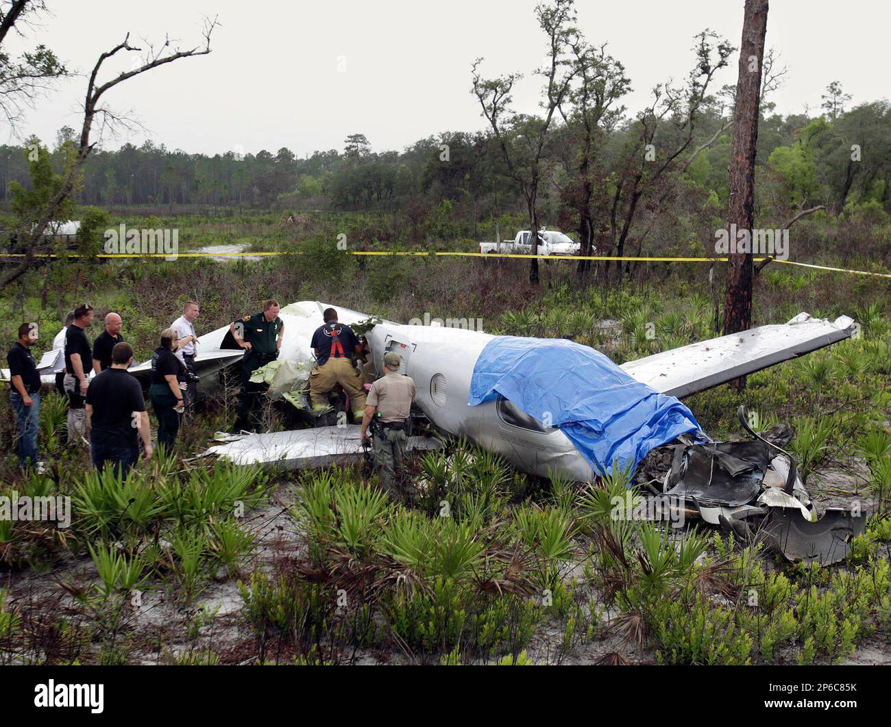 Emergency personnel investigate the site where a Pilatus PC-12, a ...