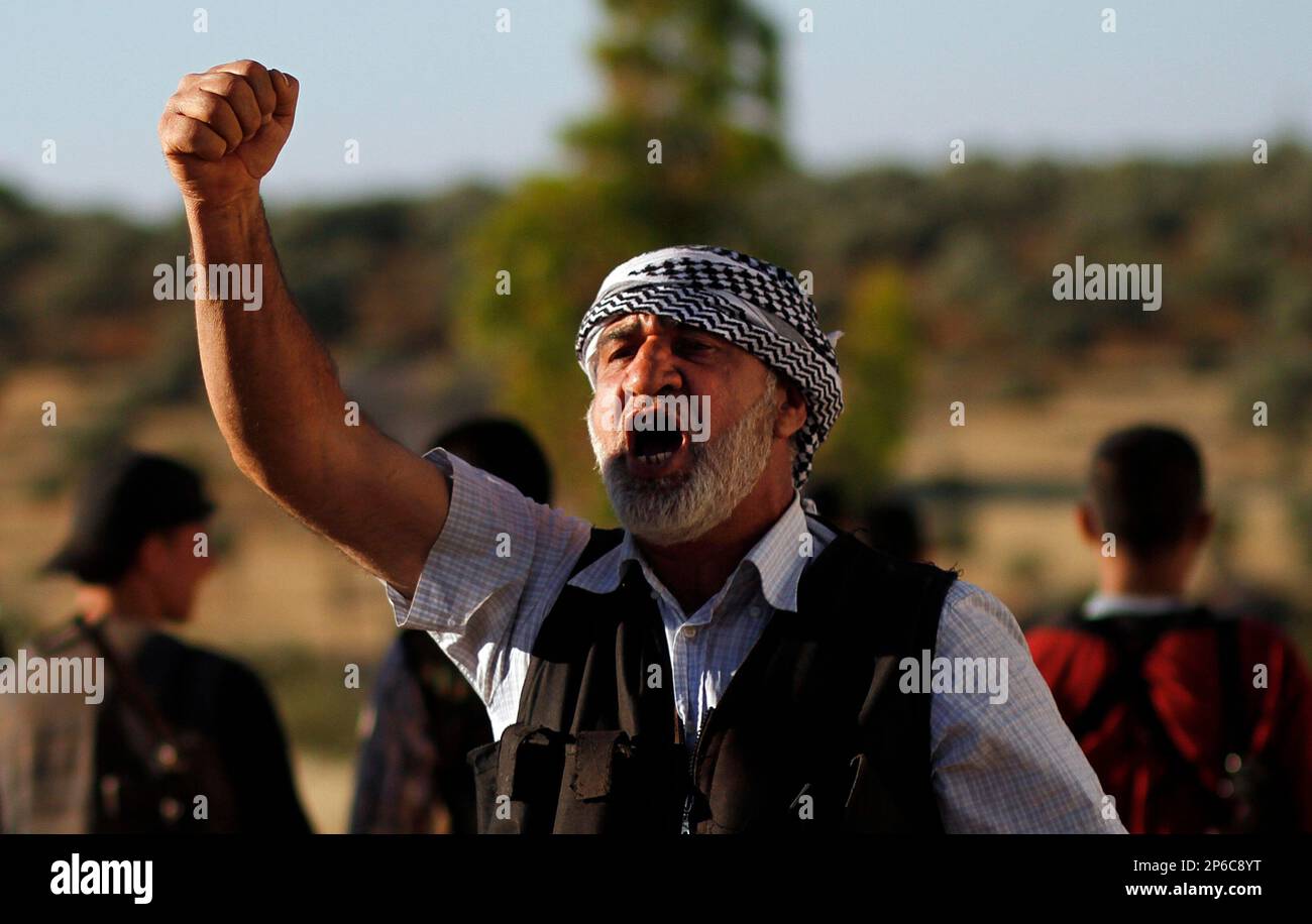 A Free Syrian Army officer chants slogans during a training session on ...