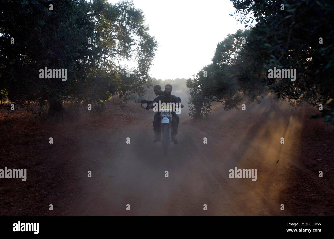 Free Syrian Army members ride a motorcycle as they train on the ...