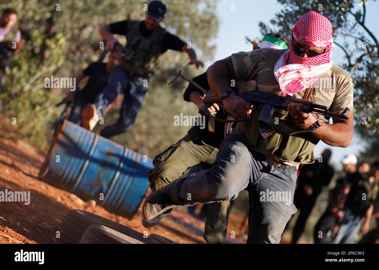 Free Syrian Army members train with their weapons on the outskirts of ...