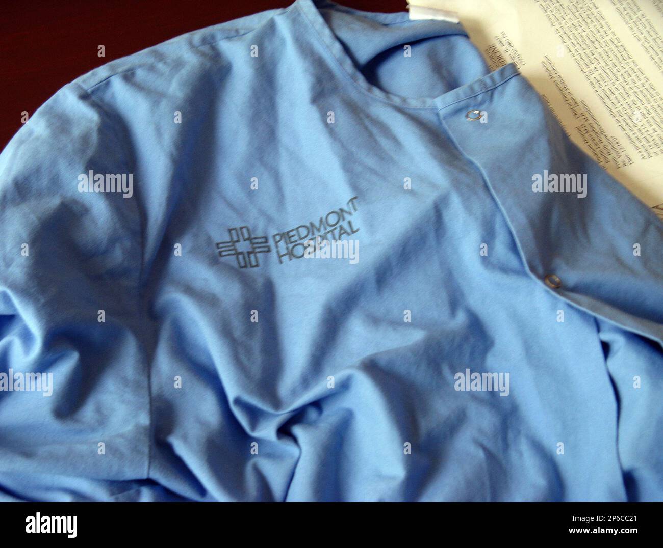 Tammi Perteet (unseen) shows a uniform and notes detailing her husband ...