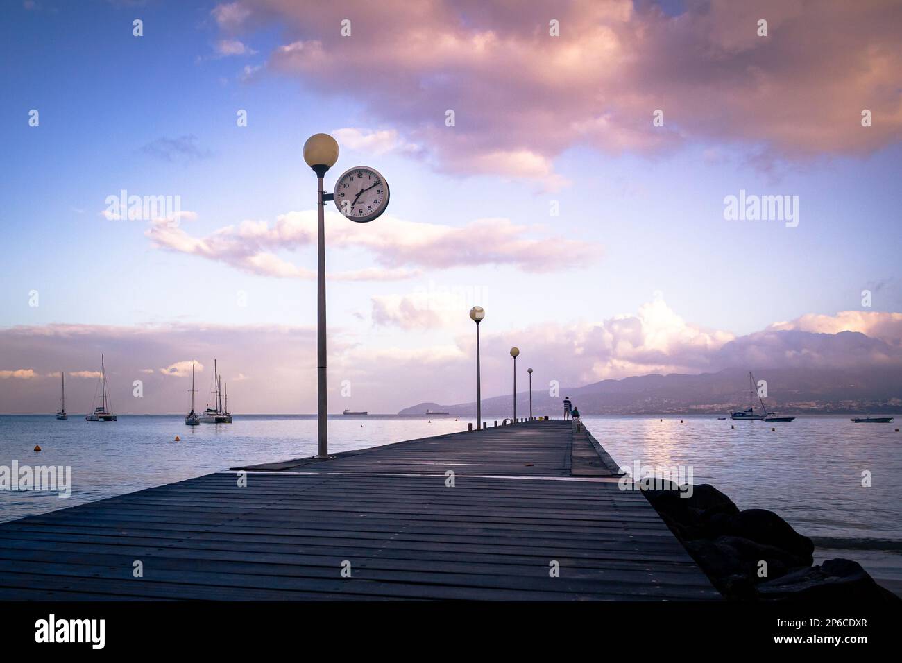 clock on a pontoon to wait for the boat at sunrise Stock Photo - Alamy