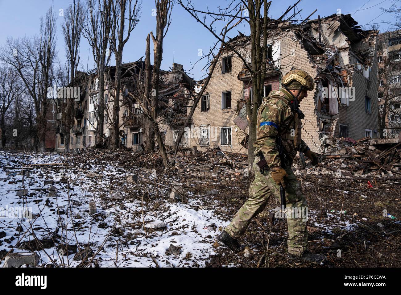 A police officer walks in front of the residential building which was ...