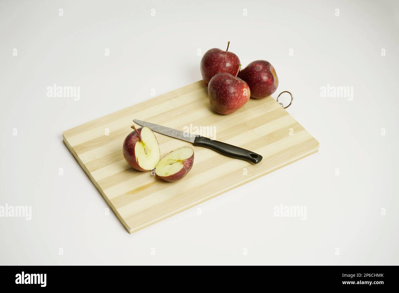 Apple with knife and Chopping Board on white Background Stock Photo - Alamy