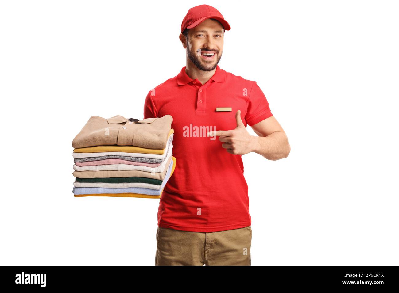 Laundry worker holding a pile of folded clothes and pointing isolated ...