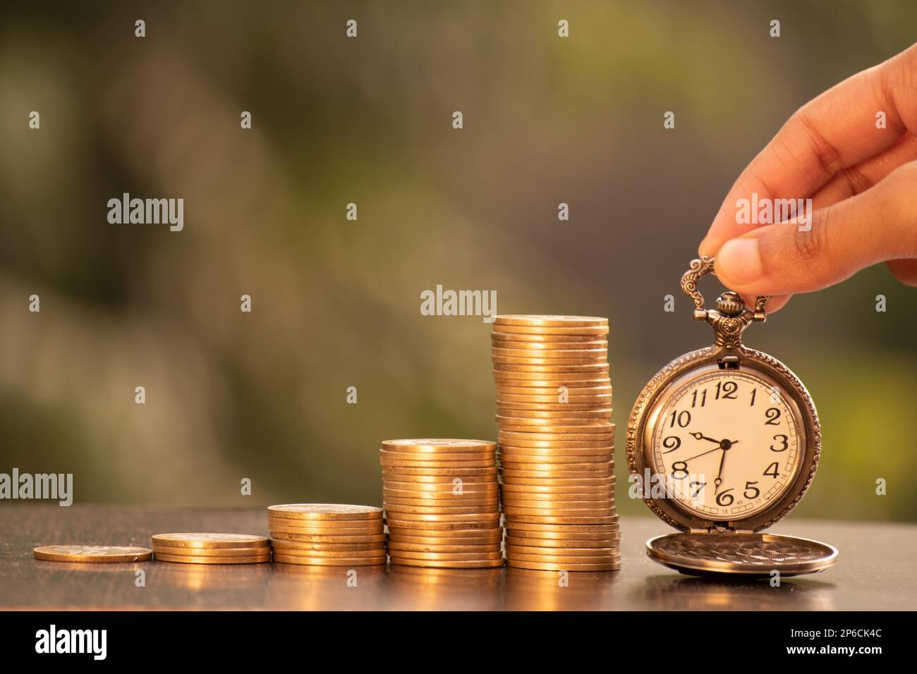 Coin stack with watch, loan repayment time limit or time is money ...