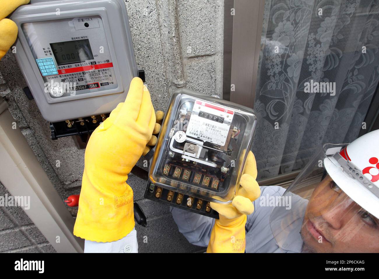An employee of Tokyo Electric Power Co. (TEPCO) installs a special ...