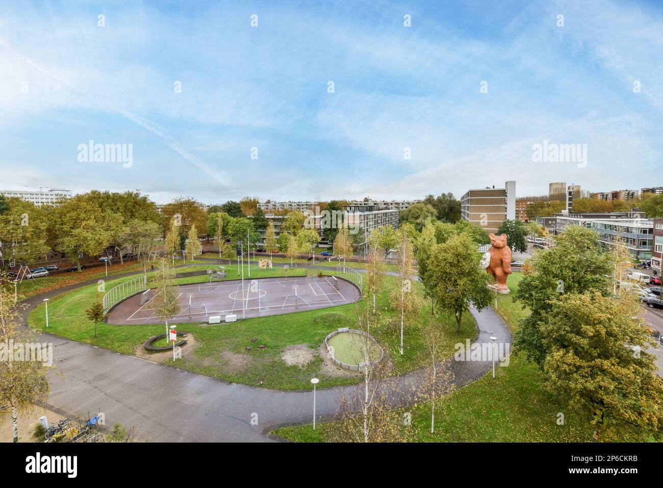 a park in the middle of an urban area with trees and buildings on ...